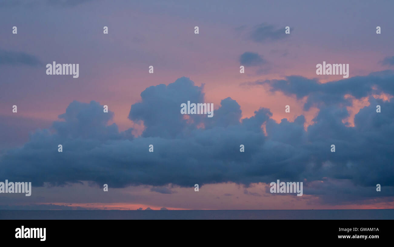 Beautiful pink and blue sunset with dramatic clouds in the sky. For ...