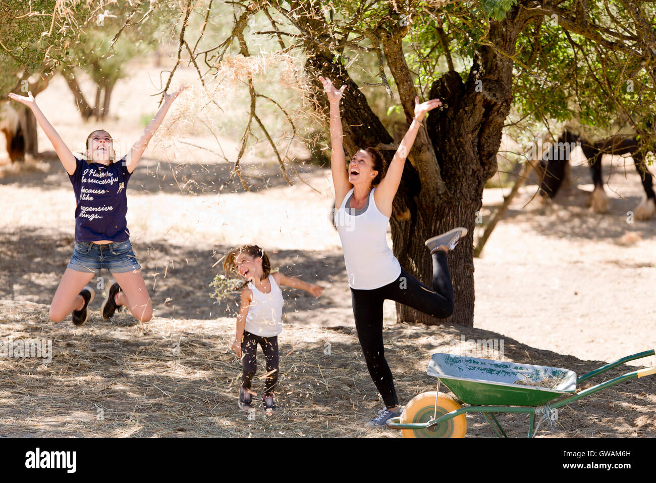 Girls playing on a horse farm Stock Photo - Alamy