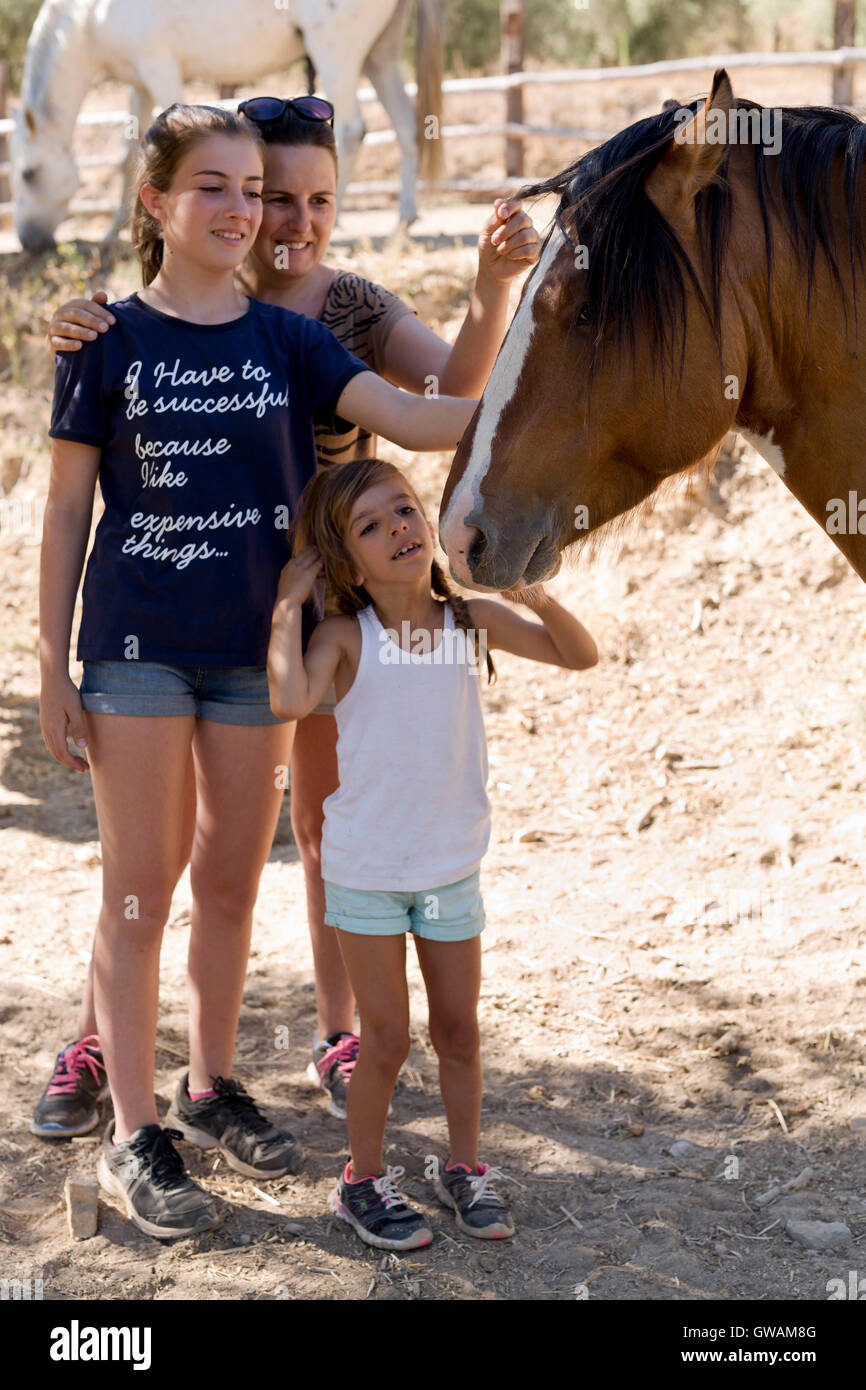 Girls with horses on a farm Stock Photo - Alamy