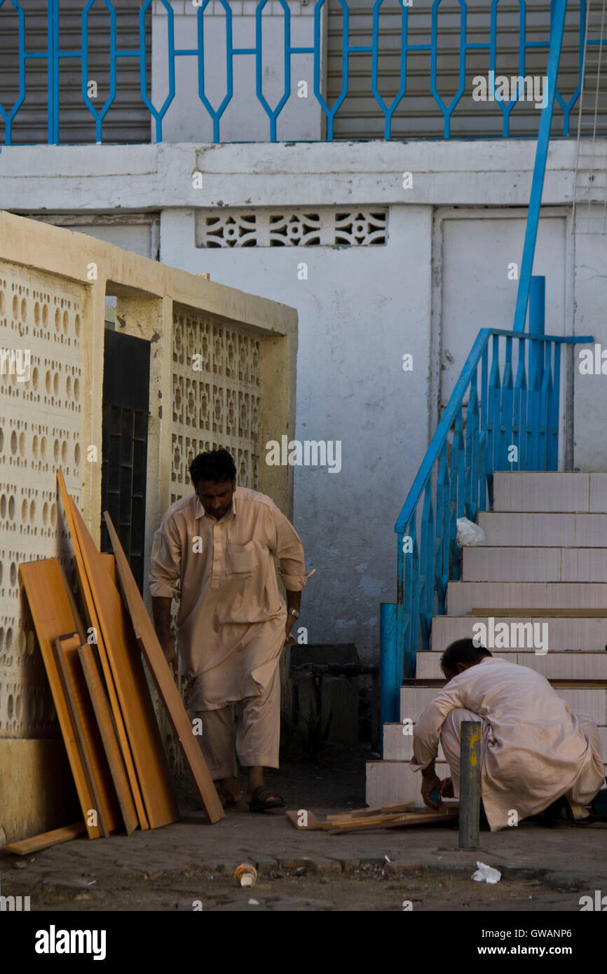 Muscat, Oman, October 19, 2013: Omani workers in the street Stock Photo ...