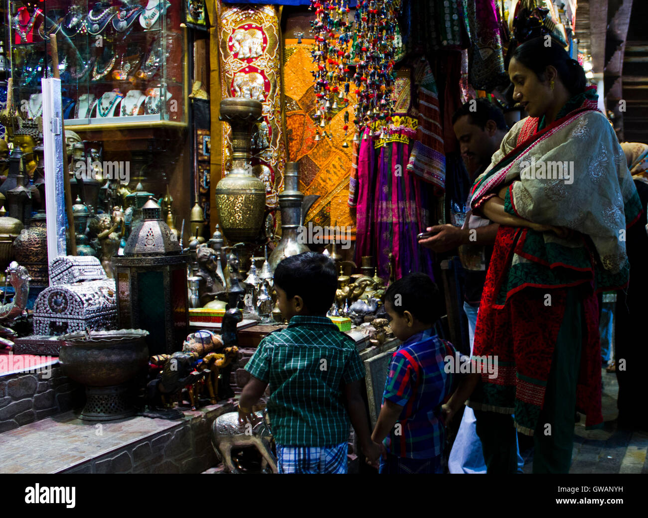 Muscat, Oman, October 19, 2013: A mother and her two son at night in a ...