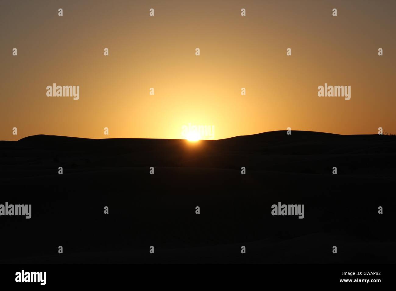 Sunset trough dunes in the desert Stock Photo - Alamy