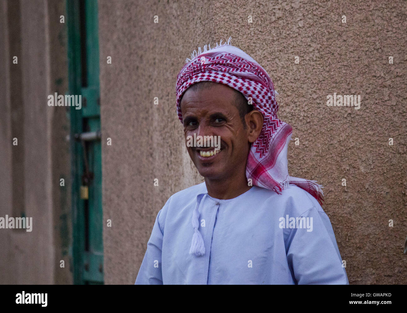 Sur, Oman, October 22, 2013: Omani man with typical dress smiling at me ...