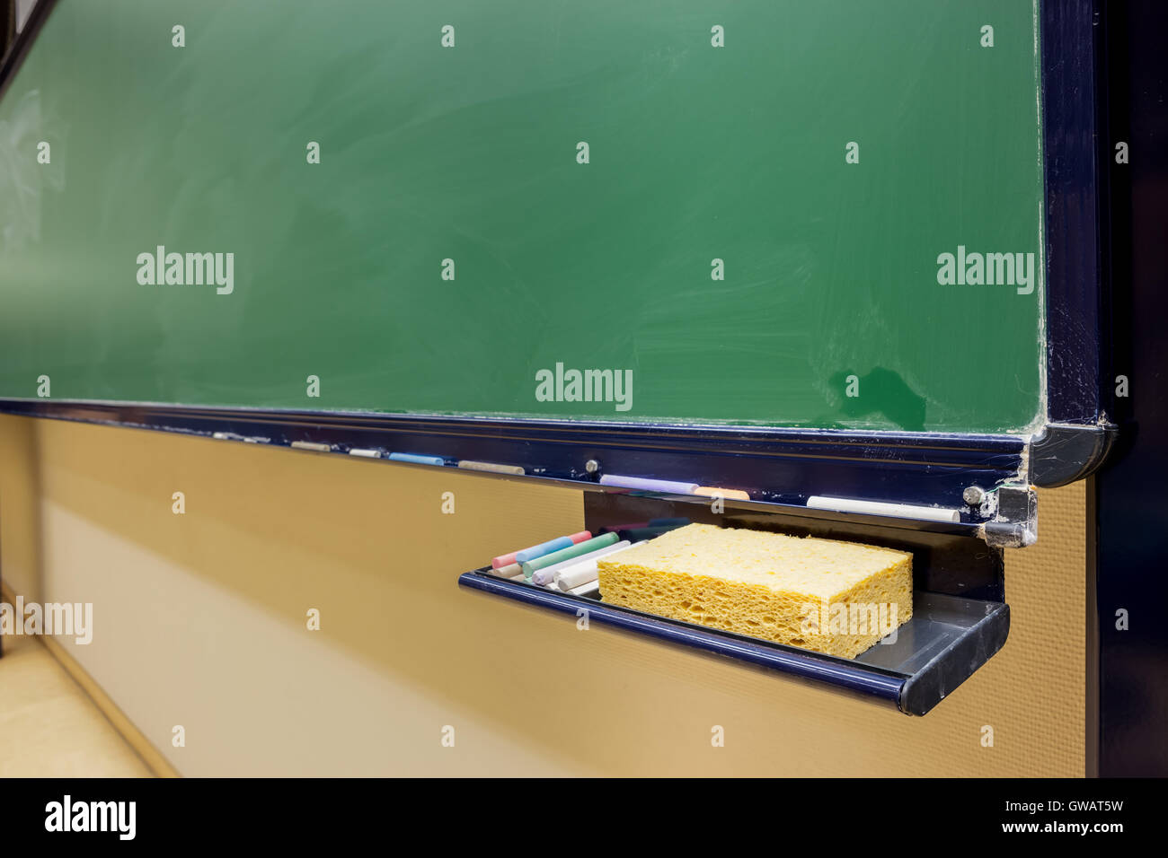 there is color chalk and sponge on the blackboard Stock Photo - Alamy