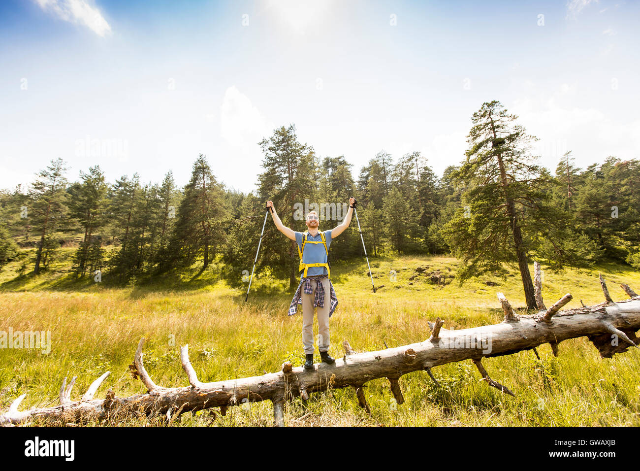 Caucasian male model with backpack hiking on sunny day Stock Photo - Alamy