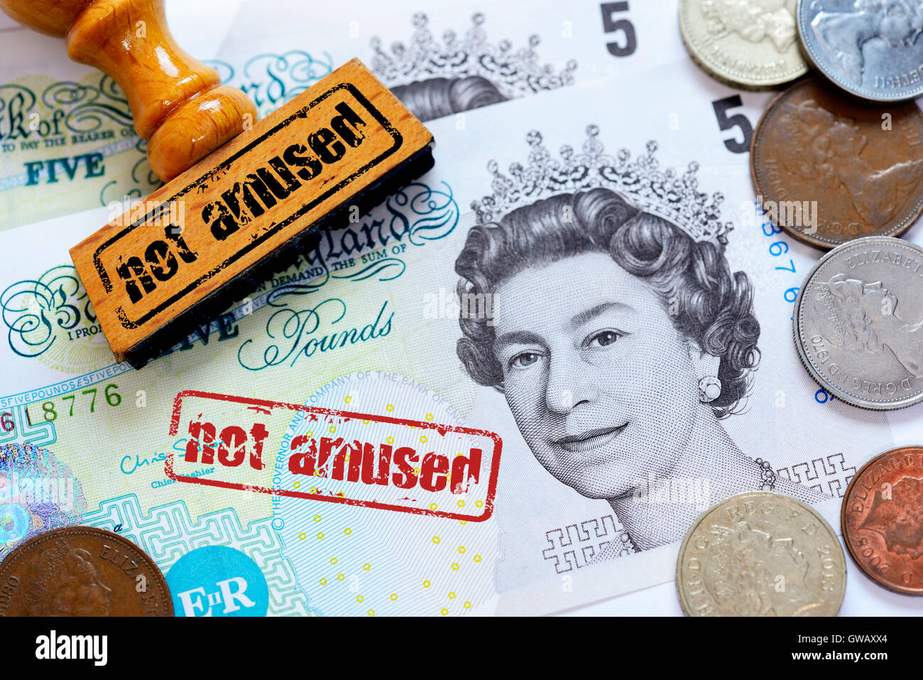 "British pound marks with stamp and label ""not amused"", symbolic ...