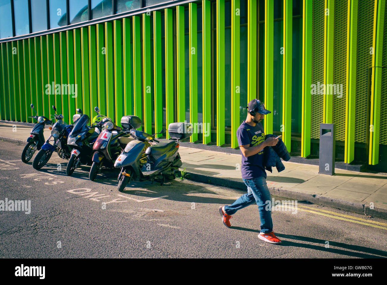 Man walking past parked motorcycle hi-res stock photography and images ...