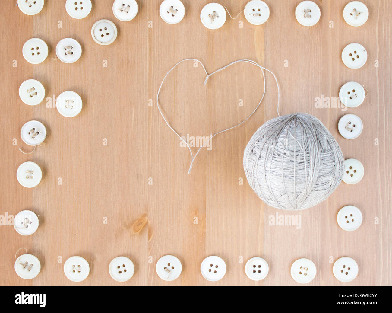 Vintage sewing buttons frame and ball of linen heart shaped thread in ...