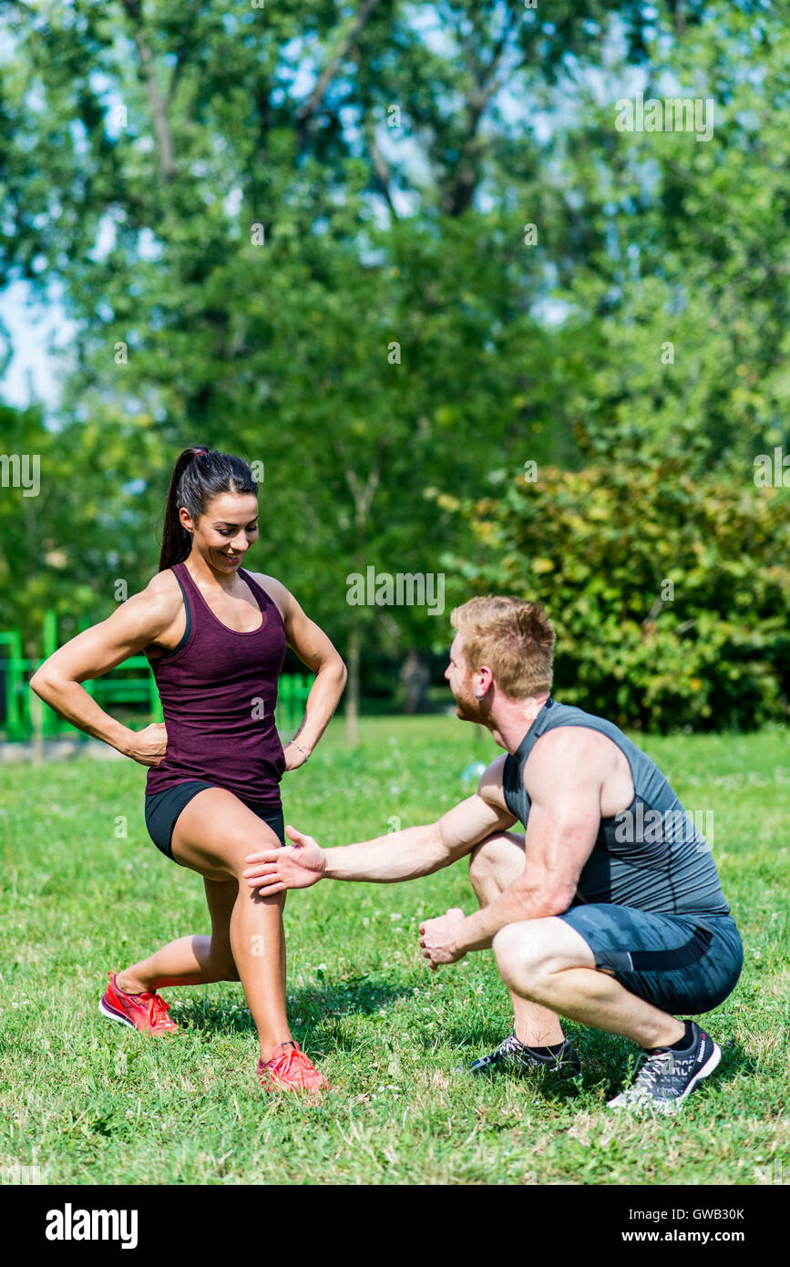 Woman training with personal trainer outdoor Stock Photo - Alamy