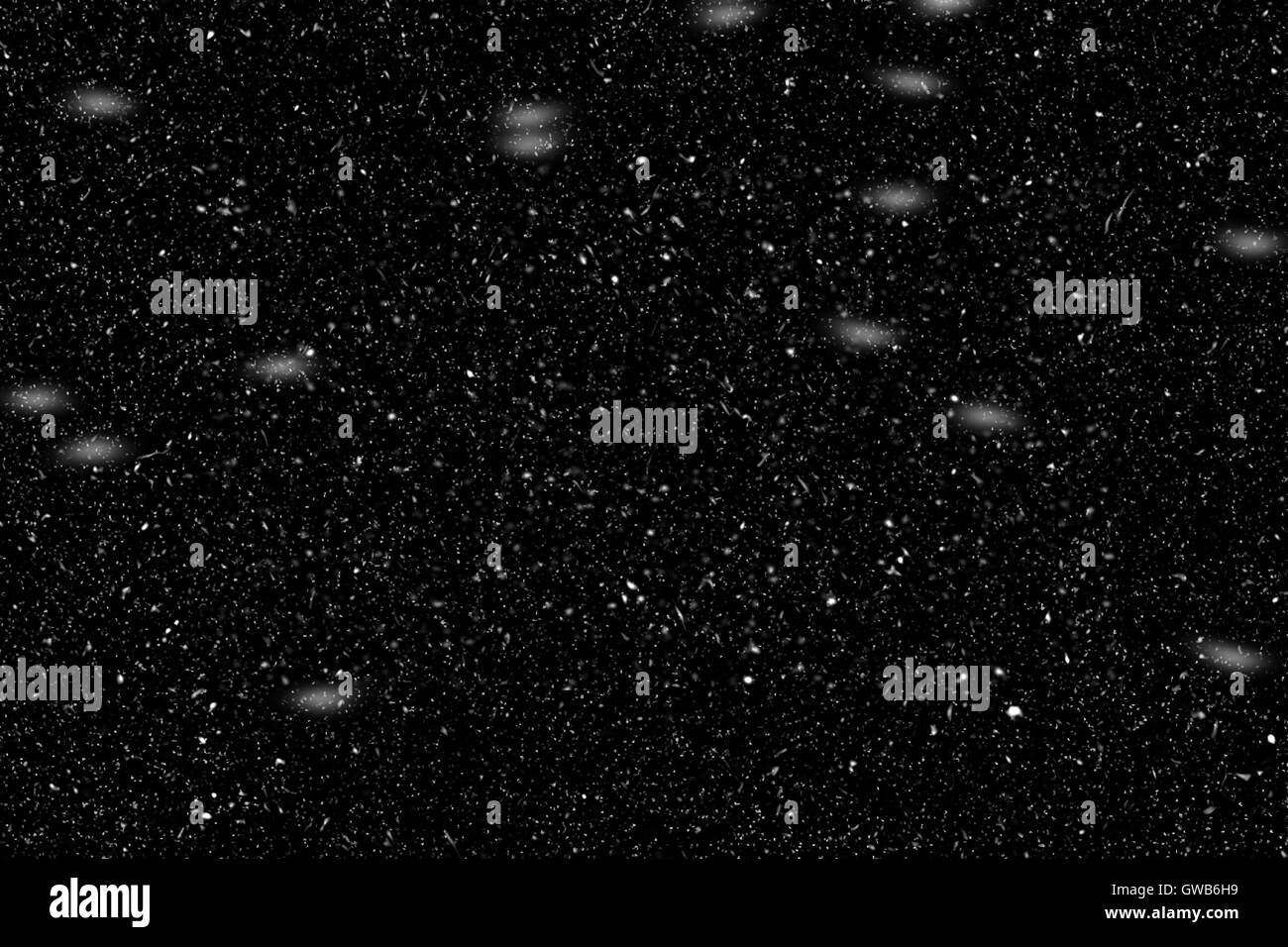 Real falling snow on a black background Stock Photo - Alamy