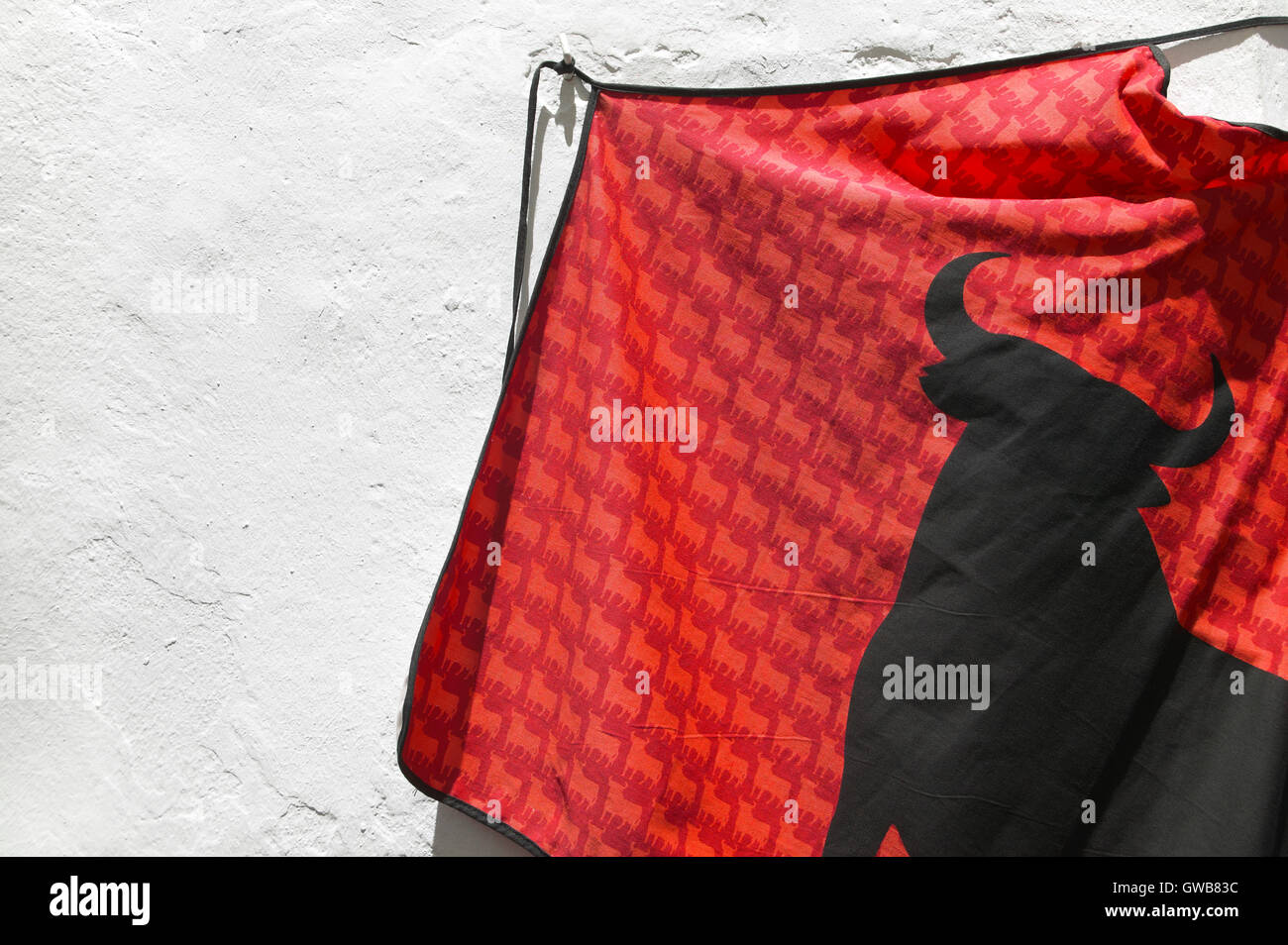 Spanish traditional apron with bull figure over a white wall ...