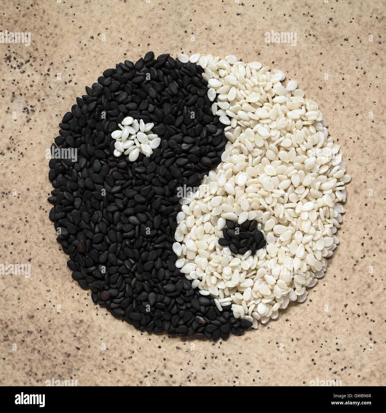 Black and white sesame seeds forming the yin and yang symbol ...