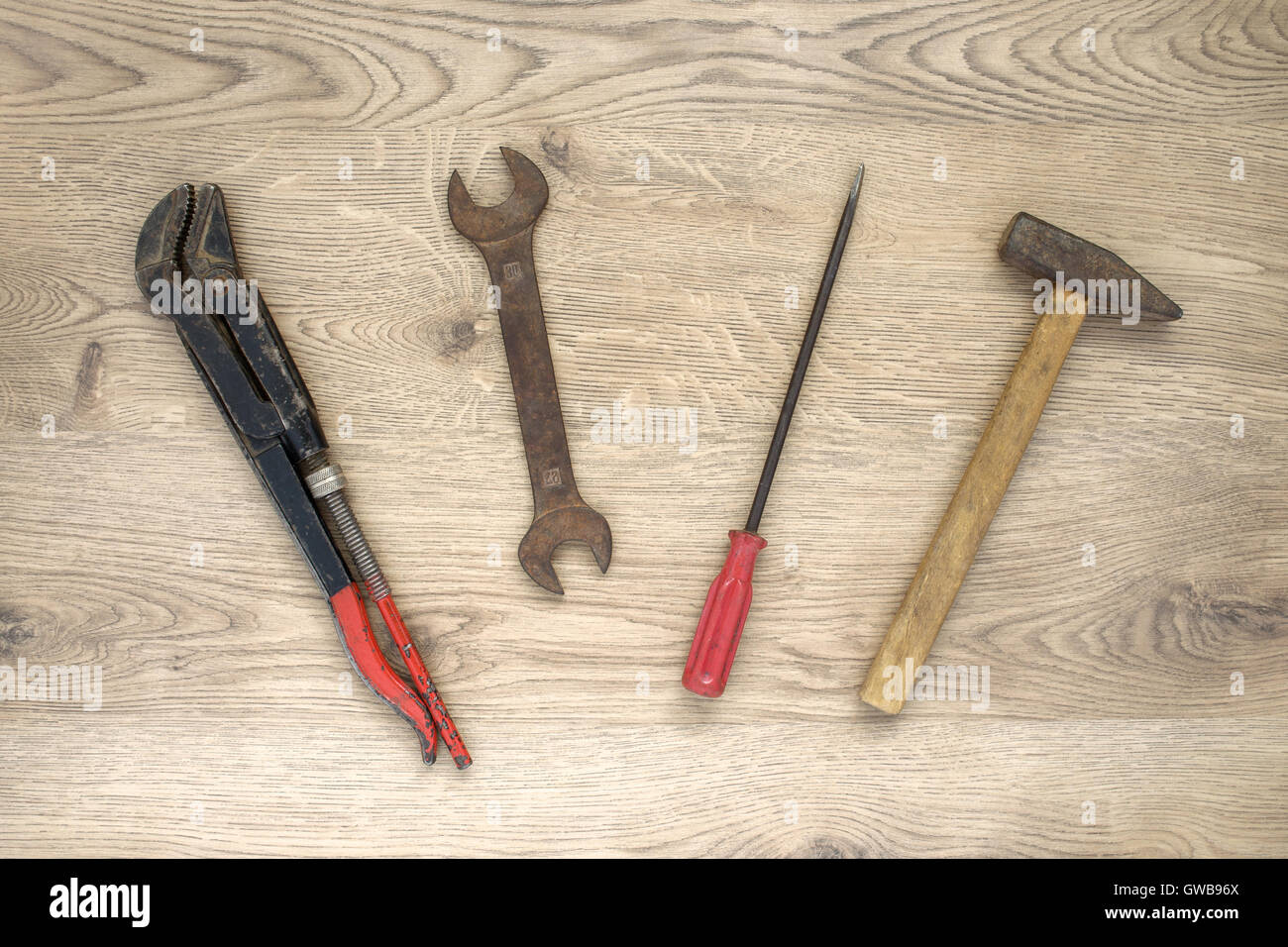 Rusty old hand tools on wooden background Stock Photo - Alamy