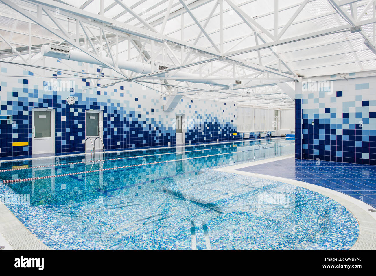 Modern indoor light swimming pool decorated with blue tiles Stock Photo ...