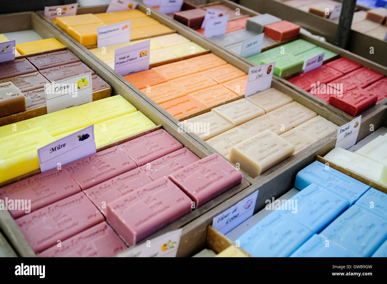 Handmade soap stall in a historic Arles market, showcasing French ...