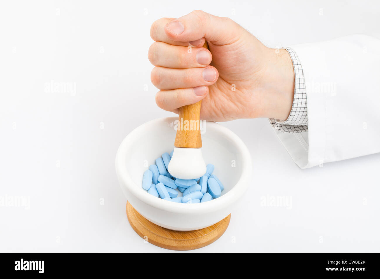 Doctor grinding some blue pills with help of mortar and pestle Stock ...
