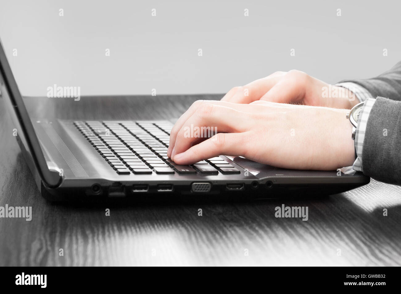 Male typing something on laptop Stock Photo - Alamy