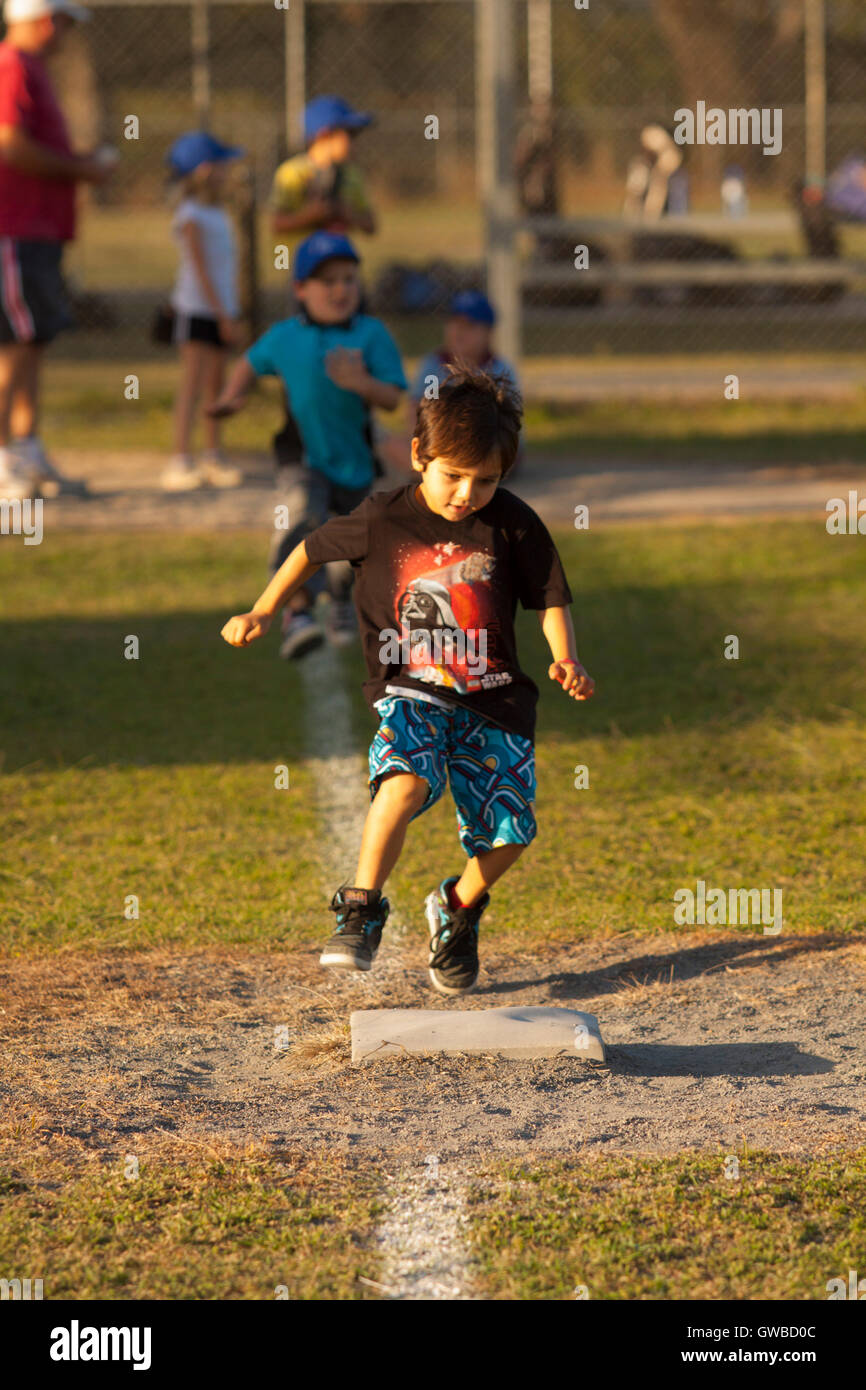 A young boy runs to first base during baseball training in Cairns ...