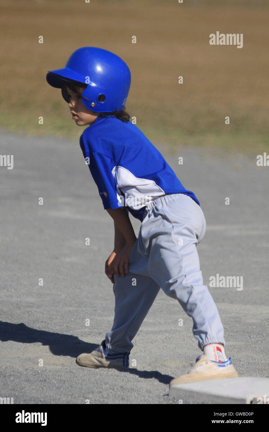 A young boy runs the bases in a baseball game in Cairns, Australia ...