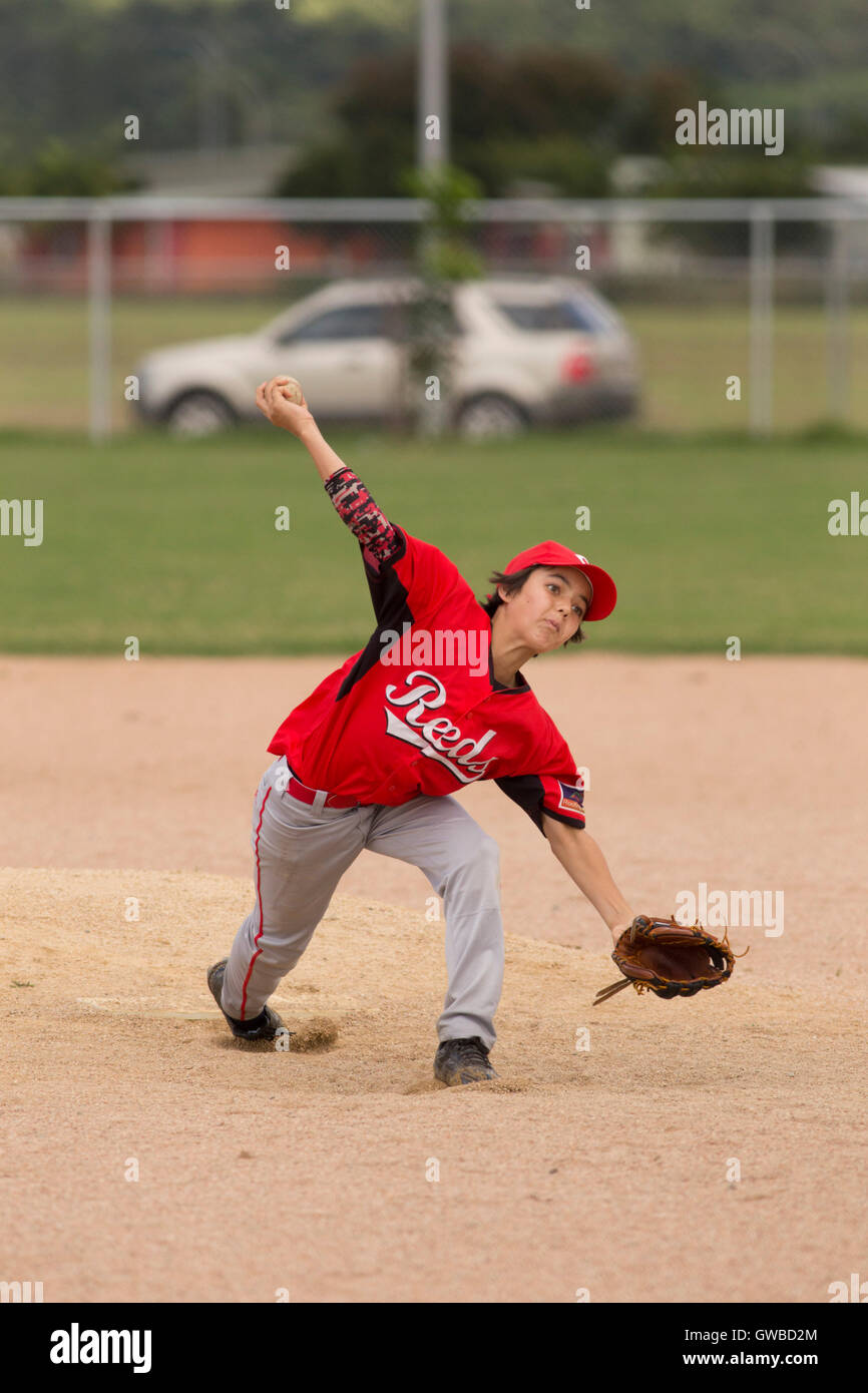 A teenage boy pitches during a baseball game in Cairns, Australia Stock ...