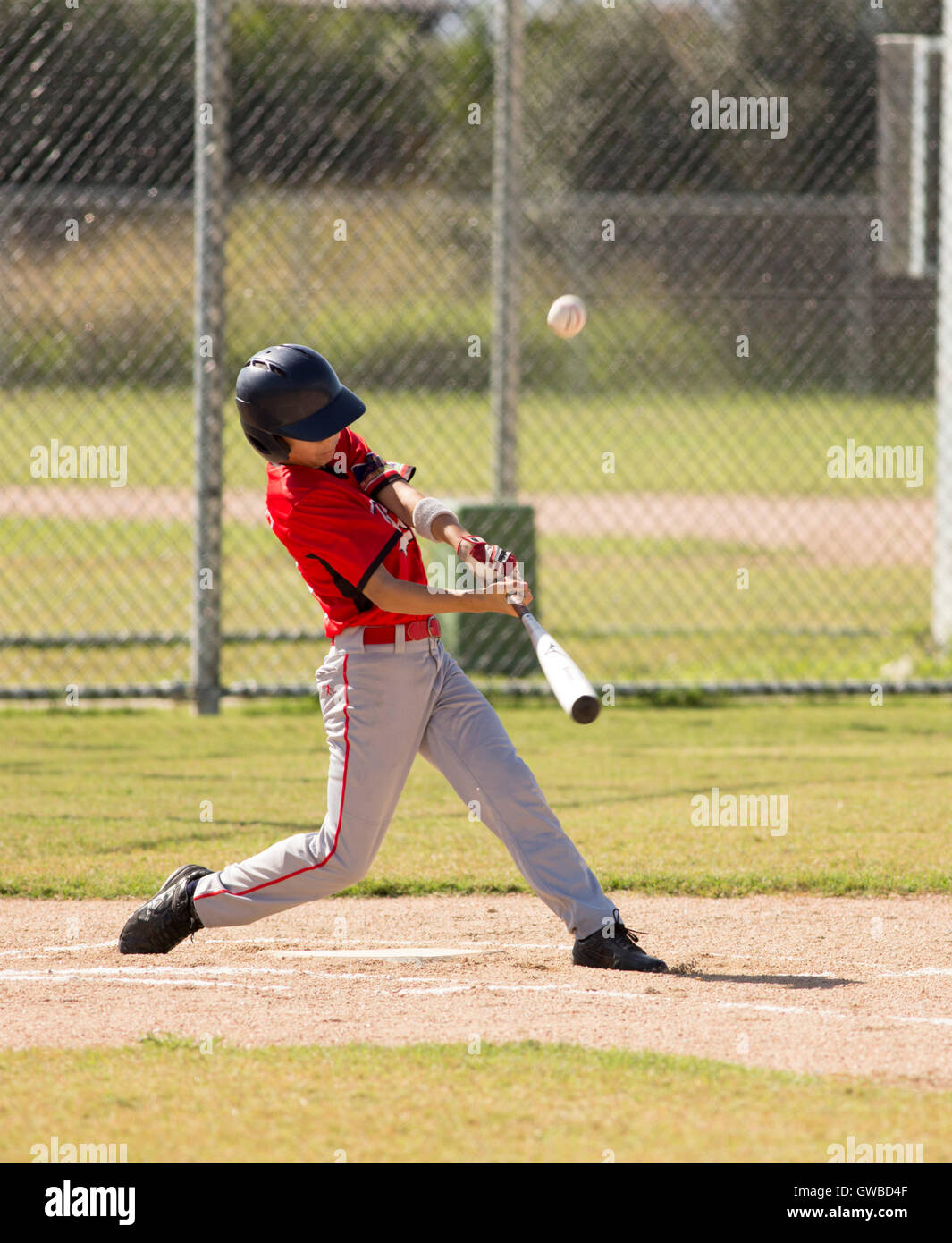 A teenage boy bats during a baseball game in Cairns, Australia Stock ...