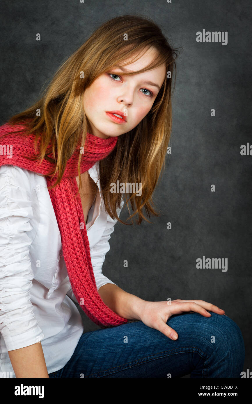 girl with a red scarf with a gray background Stock Photo - Alamy