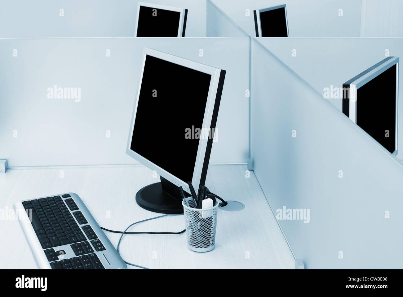 computers on a desk in a modern office Stock Photo - Alamy