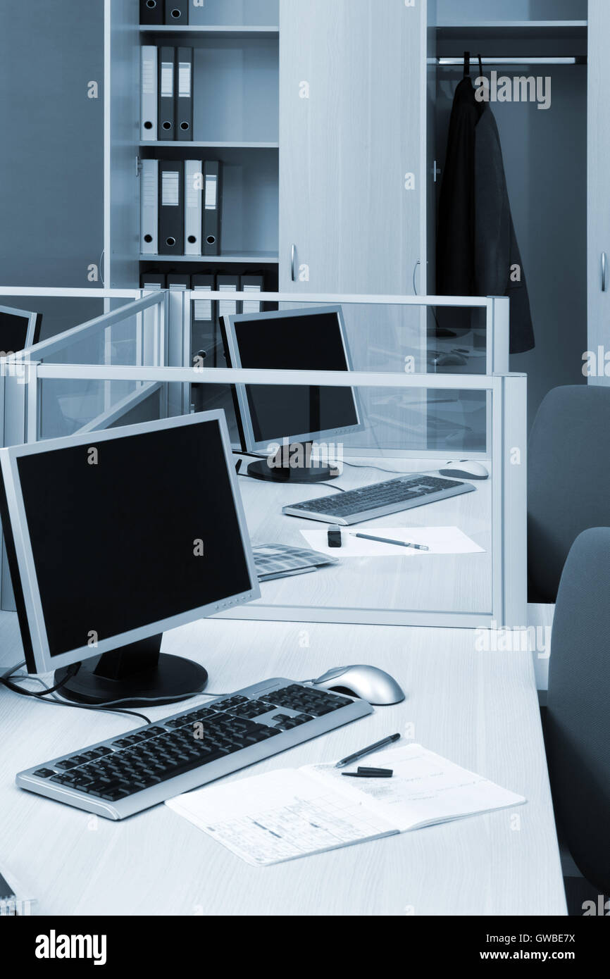 computers behind the glass in a modern office Stock Photo - Alamy