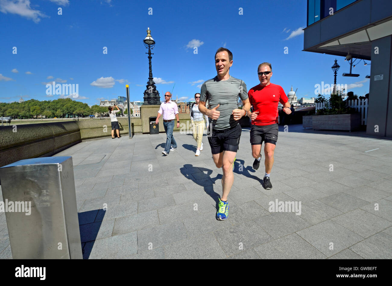 London, England, UK. Two men jogging on the South Bank Stock Photo - Alamy