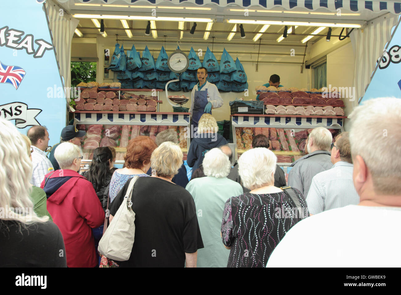 People gather around a meat auction conducted by D&M Meat Auctions from ...