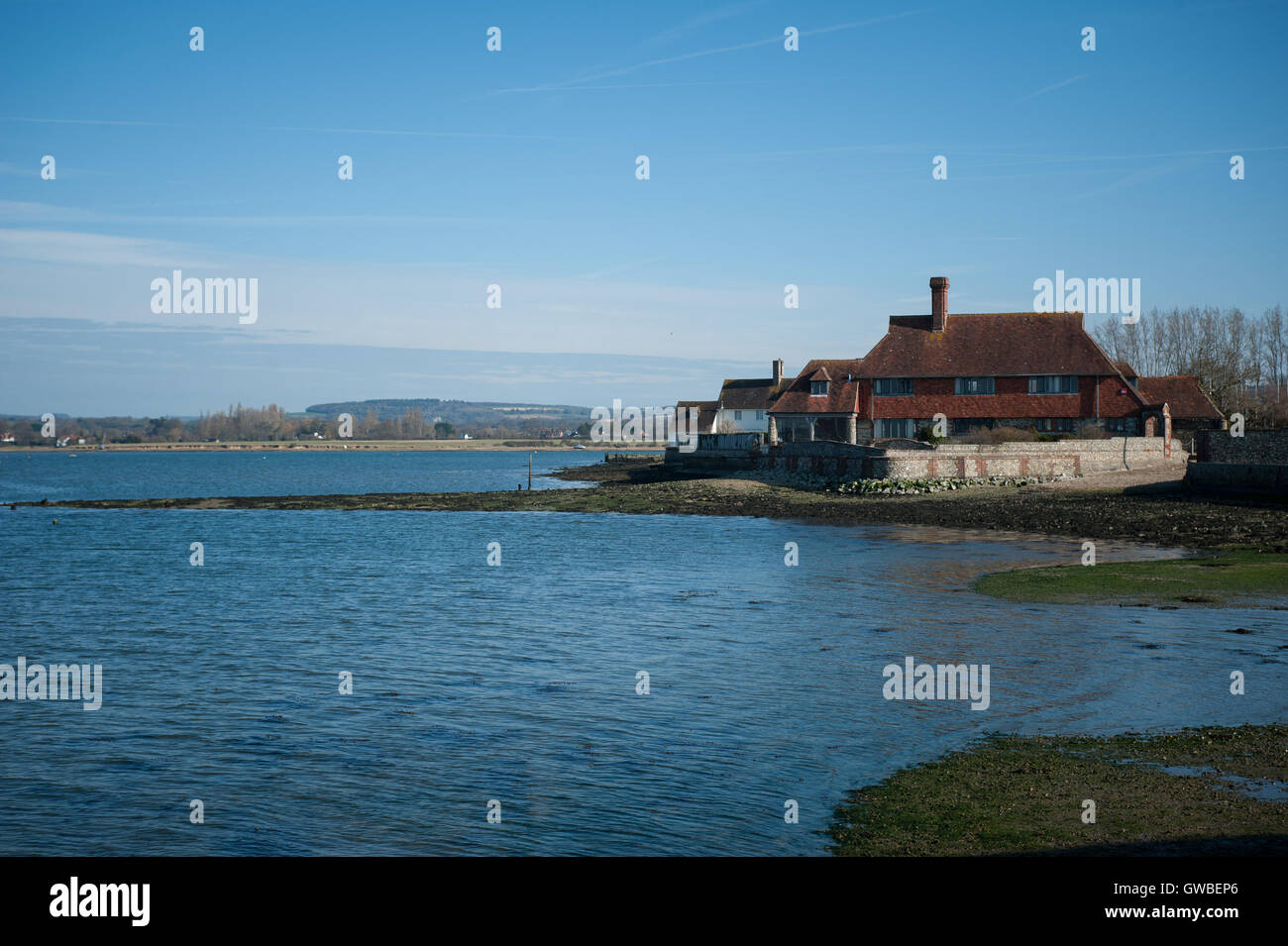 A house next to the water in the village of Bosham in West Sussex, UK ...