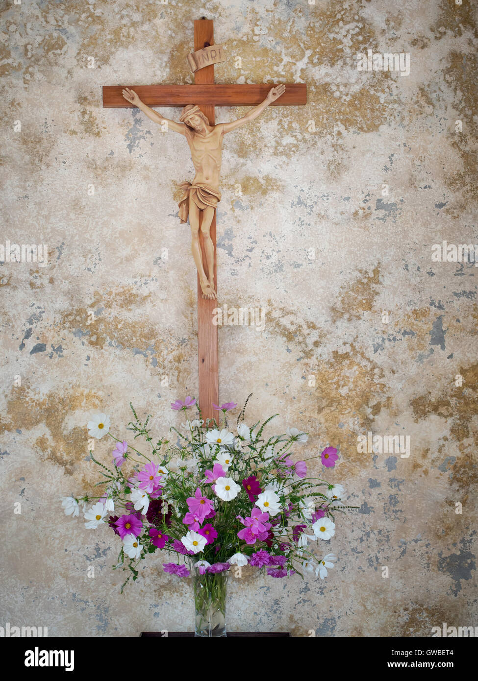 Chapel, crucifix and flowers Stock Photo - Alamy