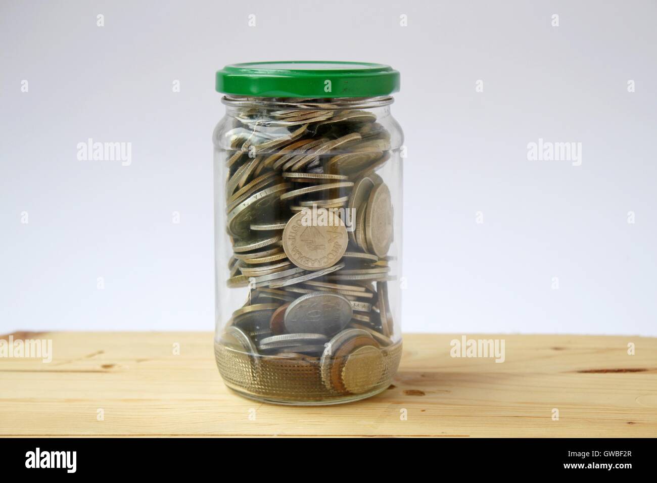 Coins money jar hi-res stock photography and images - Alamy