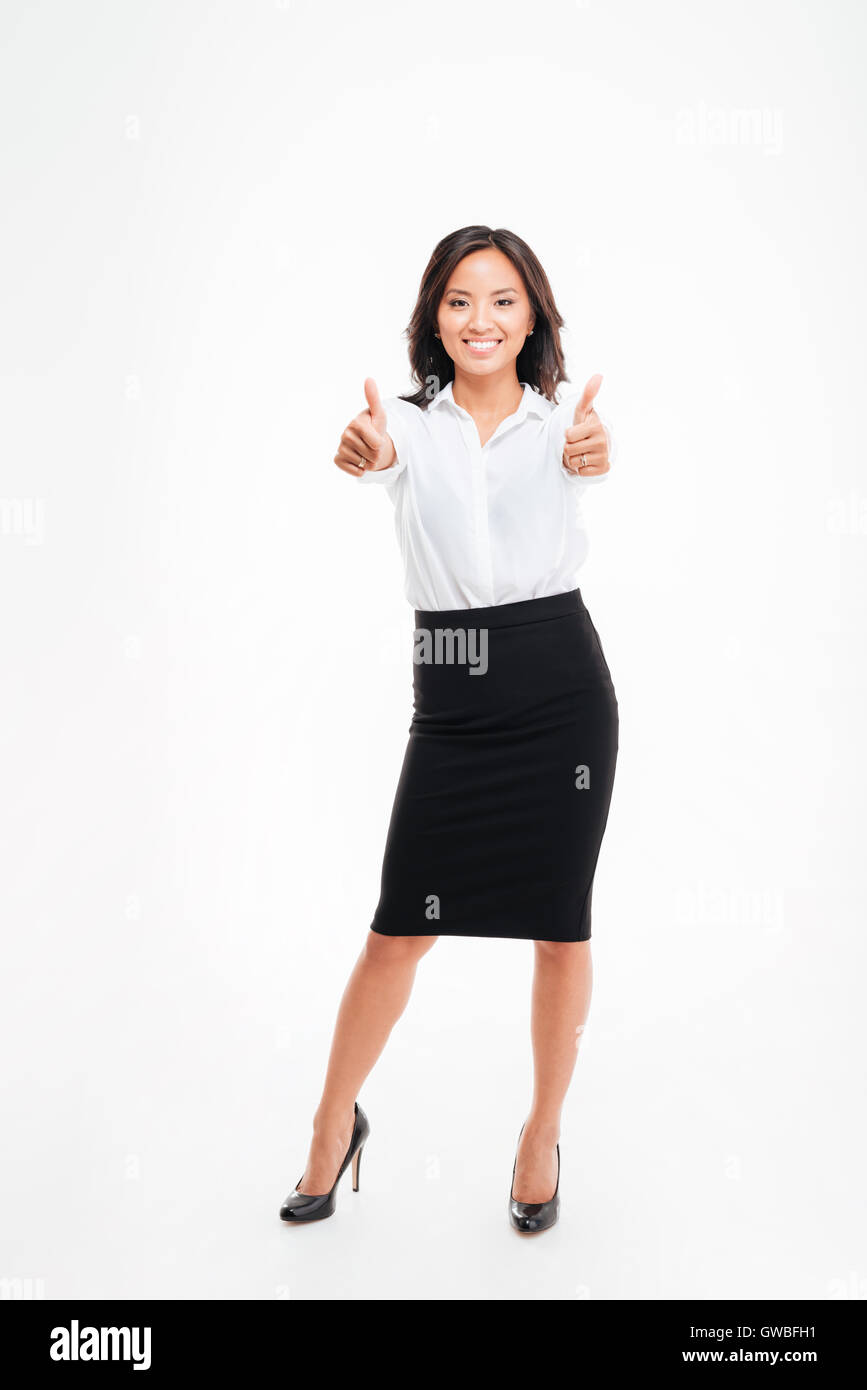 Smiling young asian businesswoman showing thumbs up with two hands isolated on a white ...
