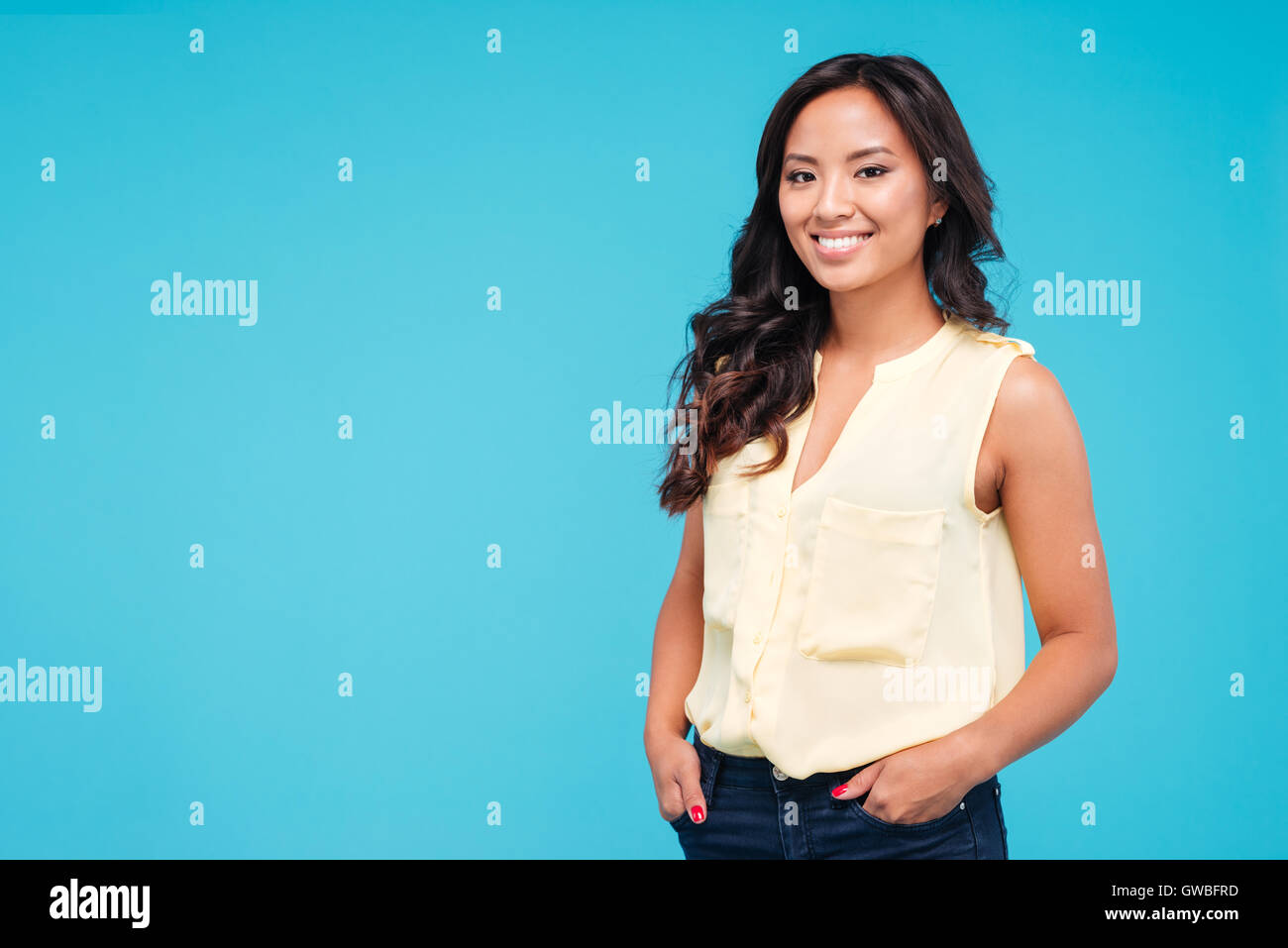 Portrait of confident beautiful young asian woman standing with hands ...