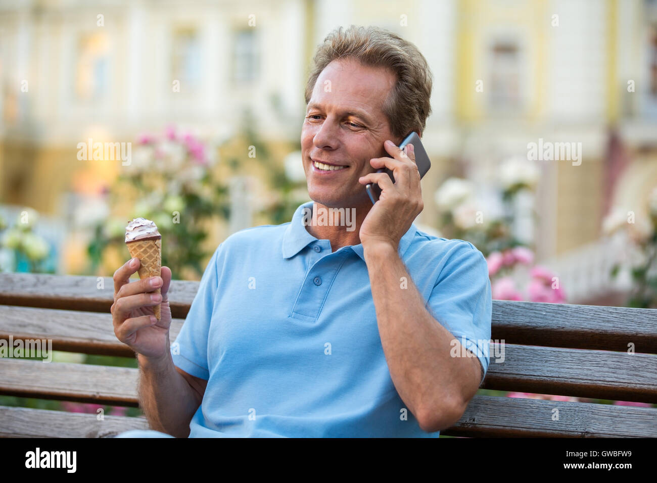 Man with phone is smiling Stock Photo - Alamy