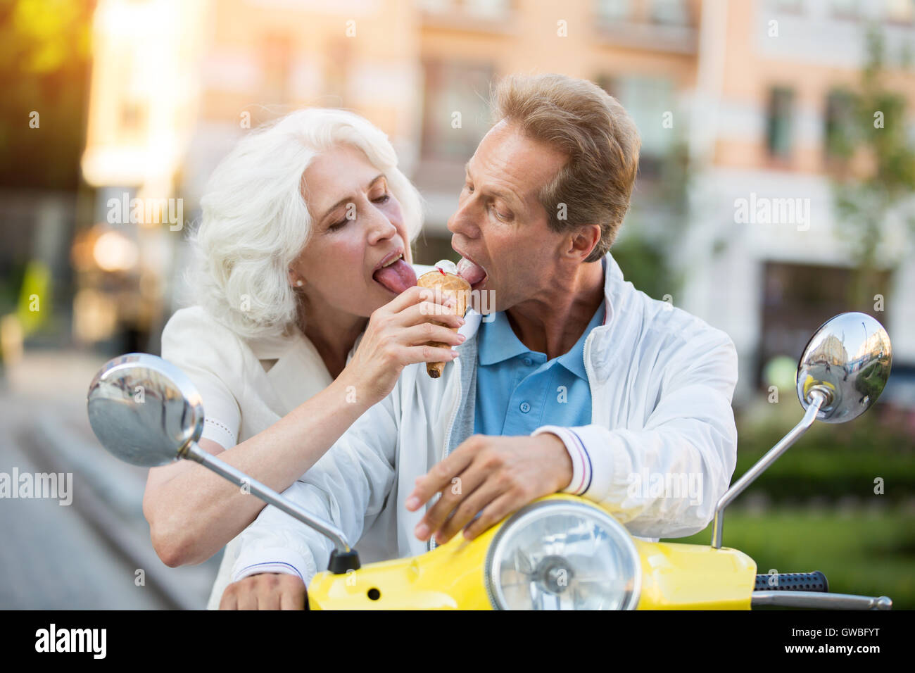 Mature couple sharing ice cream Stock Photo - Alamy