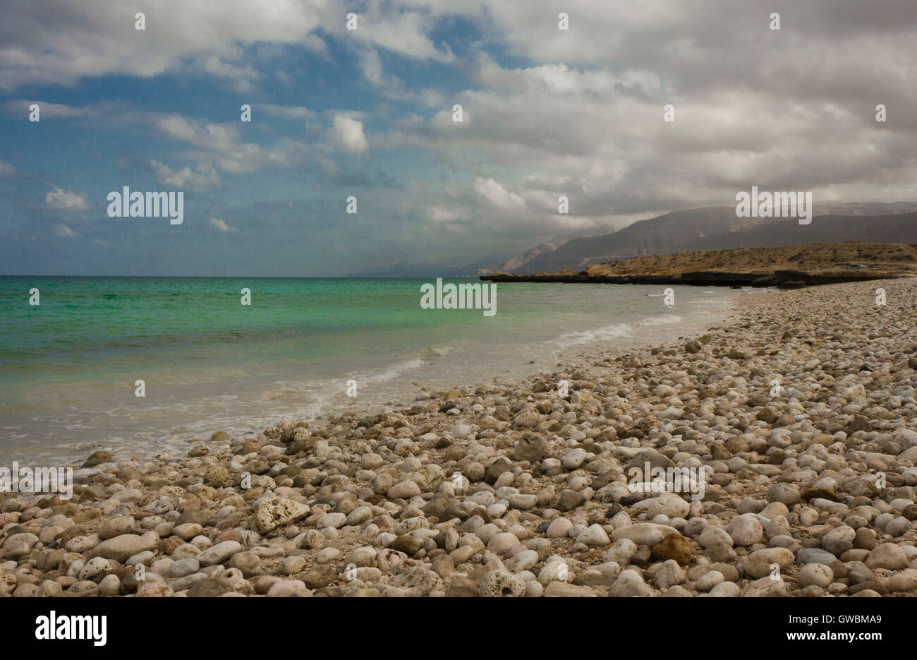 Omani paradisiac shingle beach Stock Photo - Alamy