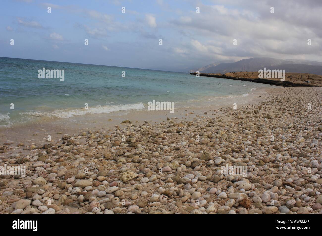 Omani paradisiac shingle beach Stock Photo - Alamy