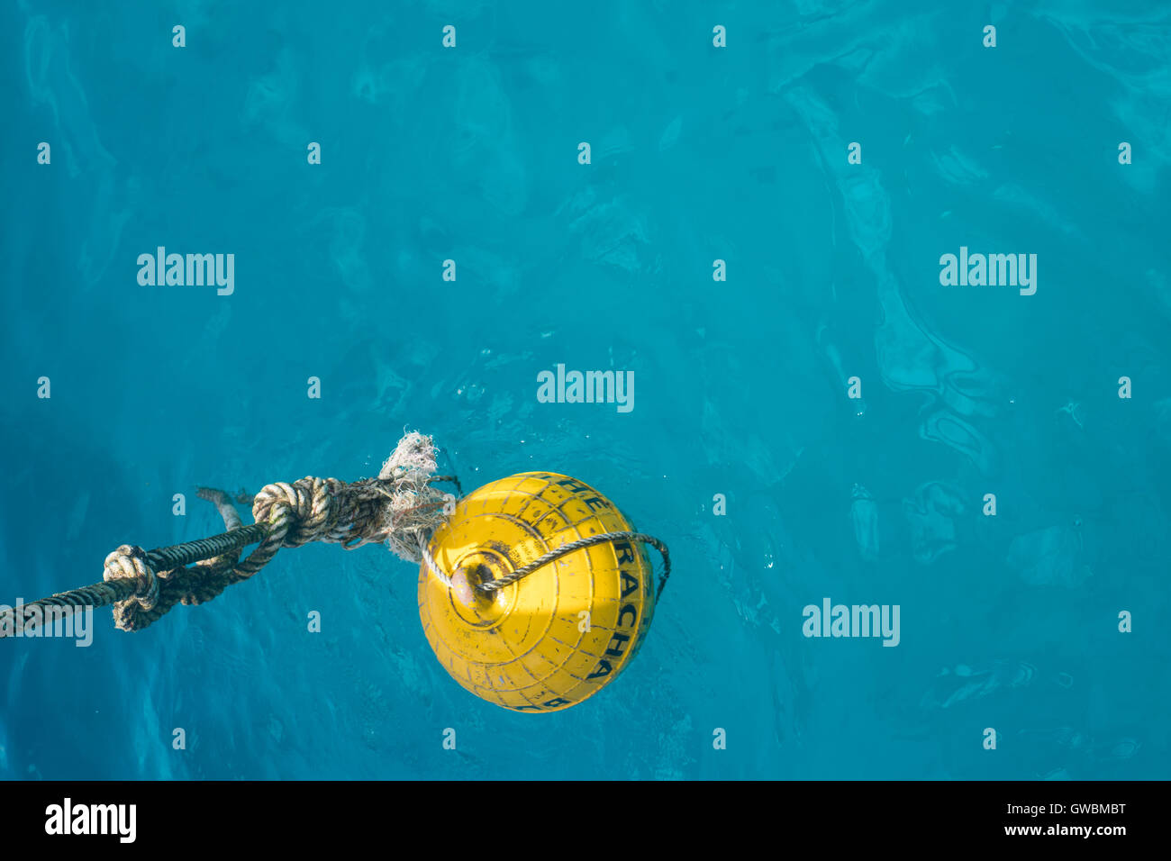 Yellow mooring buoy in the sea, mark-point coral reef zone beside the ...