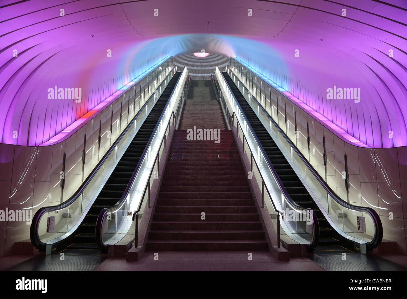 Two Escalators with Pink Light overhead Stock Photo - Alamy