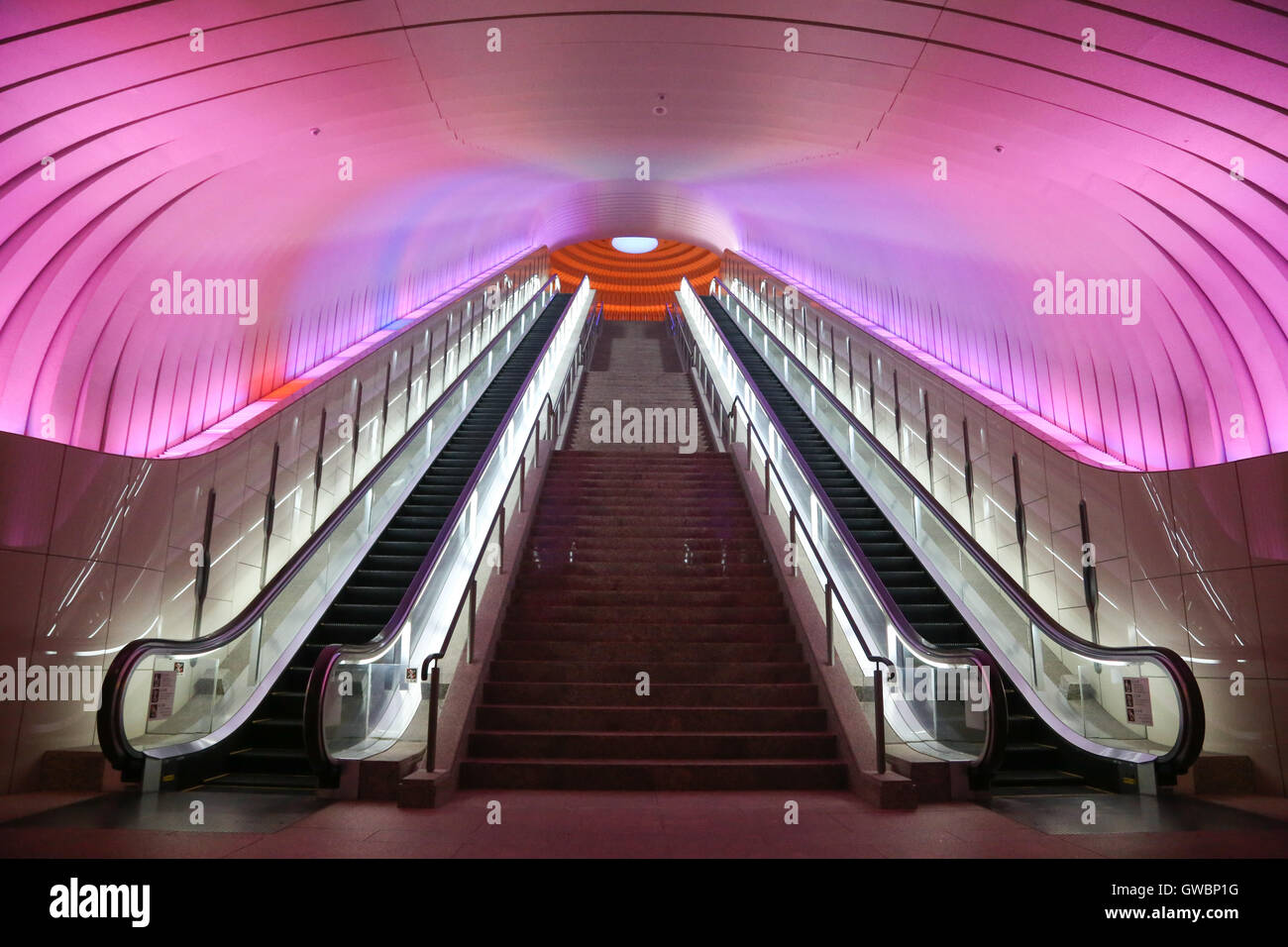 Two Escalators with Pink Light overhead Stock Photo - Alamy
