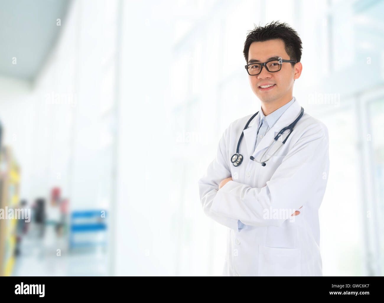 Asian doctor standing at hospital corridor Stock Photo - Alamy
