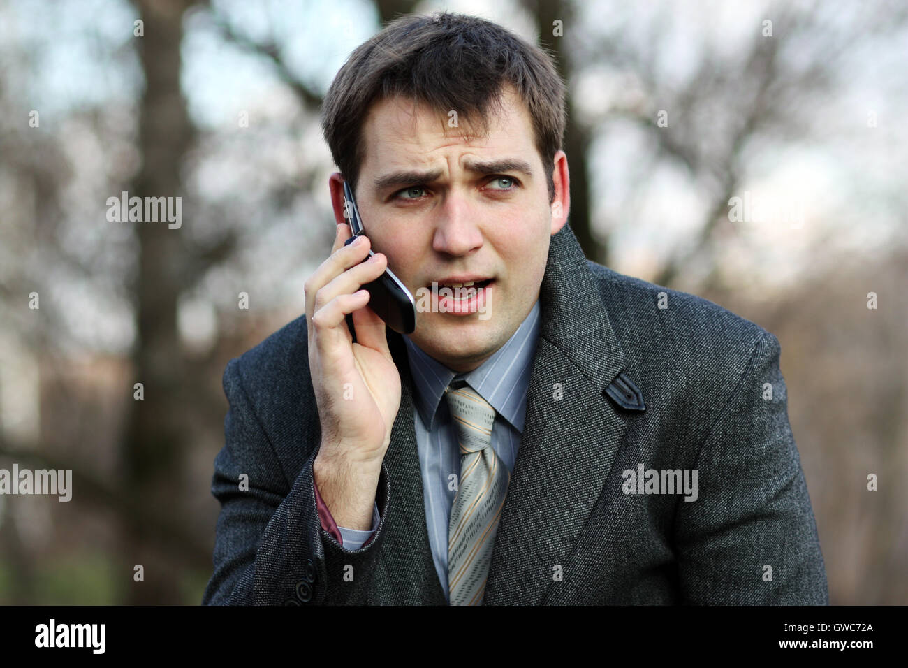 Portrait of young attractive man calling by phone Stock Photo - Alamy