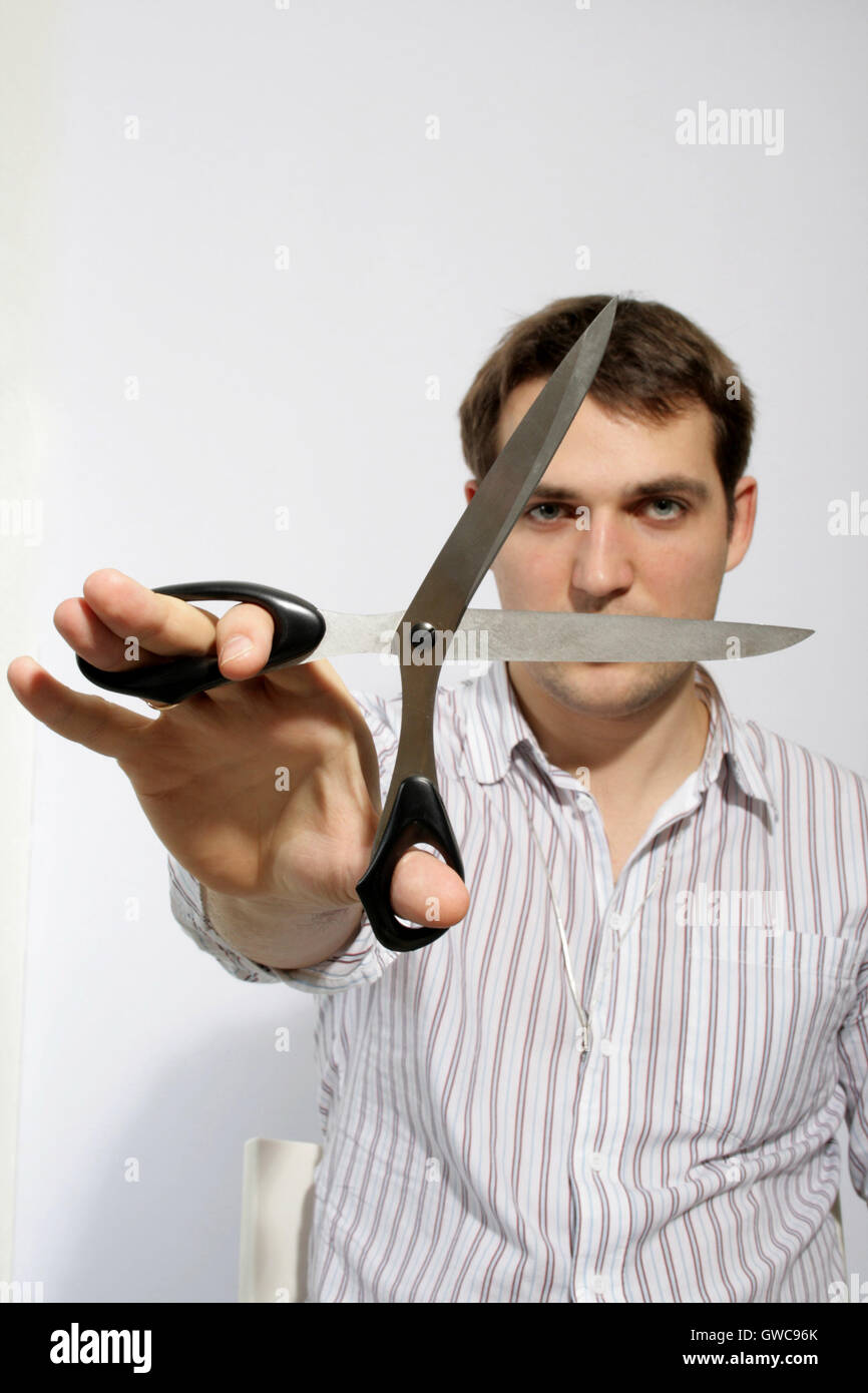 a man with scissors in hand Stock Photo - Alamy