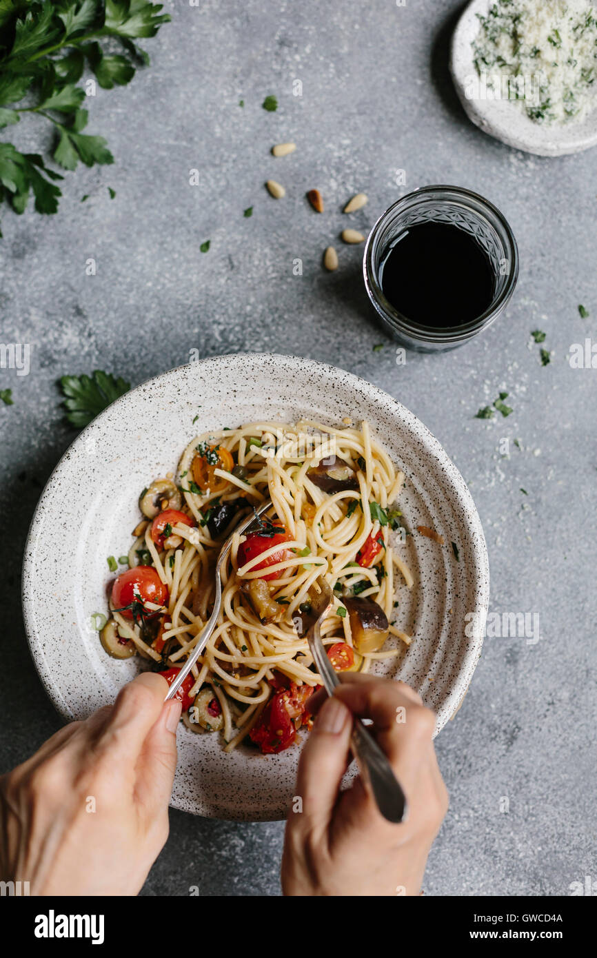 A woman's hands are photographed as she is rolling spaghetti Stock ...