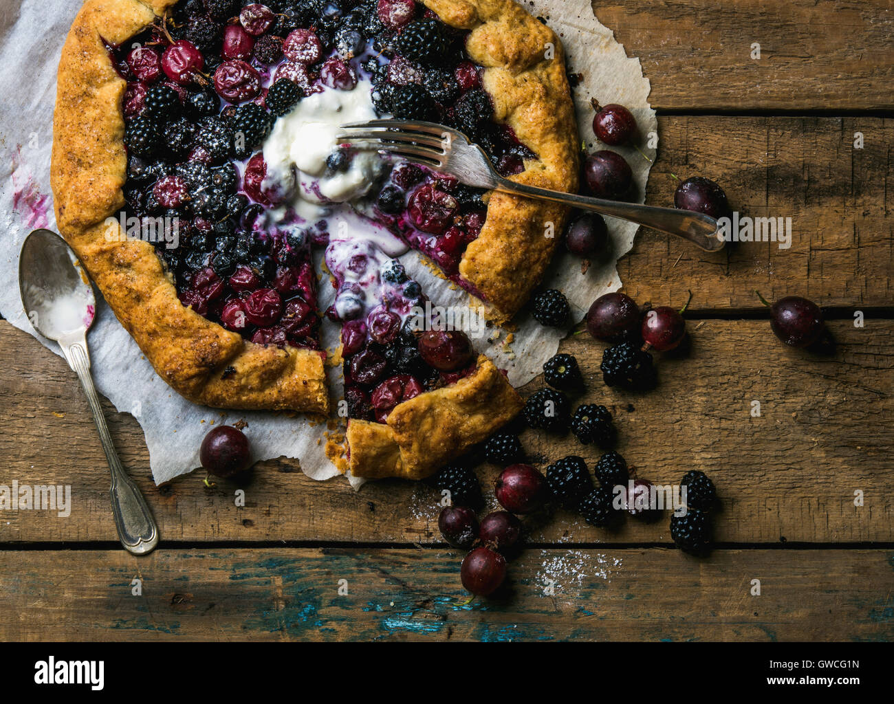 Homemade garden berry galetta or crostata sweet pie with melted vanilla ...