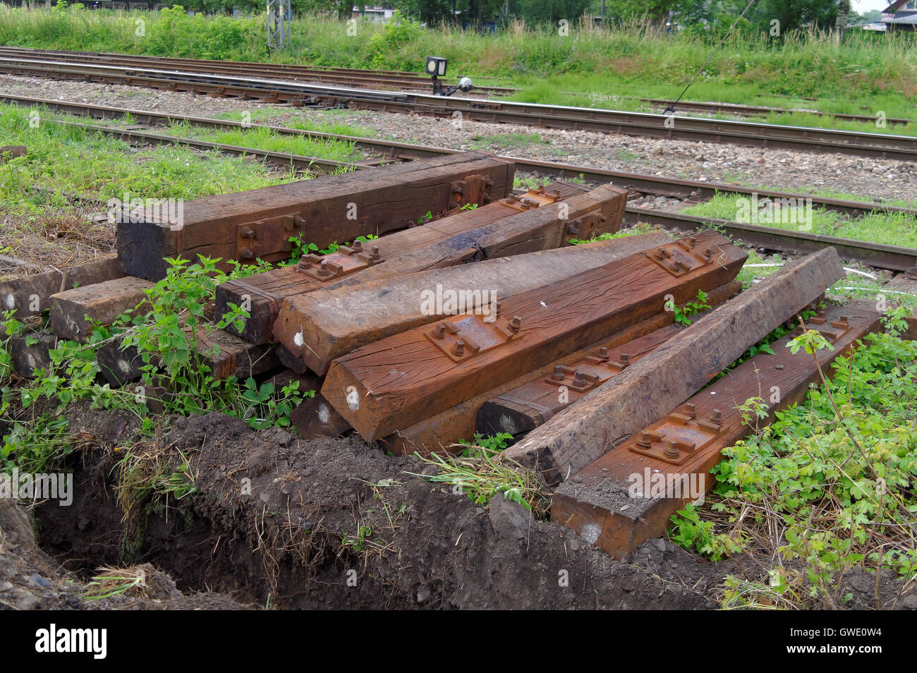 stacked old used wooden sleepers beside the railway Stock Photo - Alamy