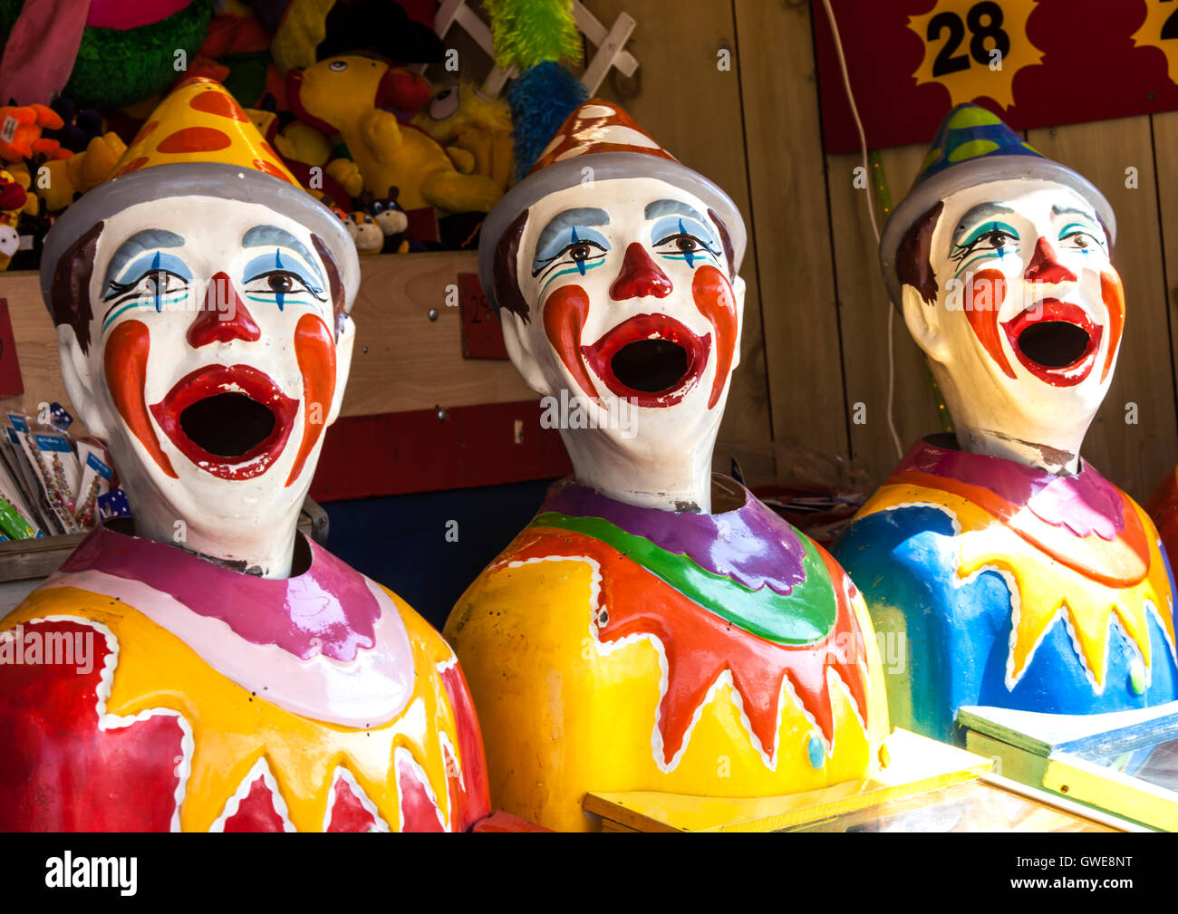 Fun fair clowns at side show alley Stock Photo - Alamy