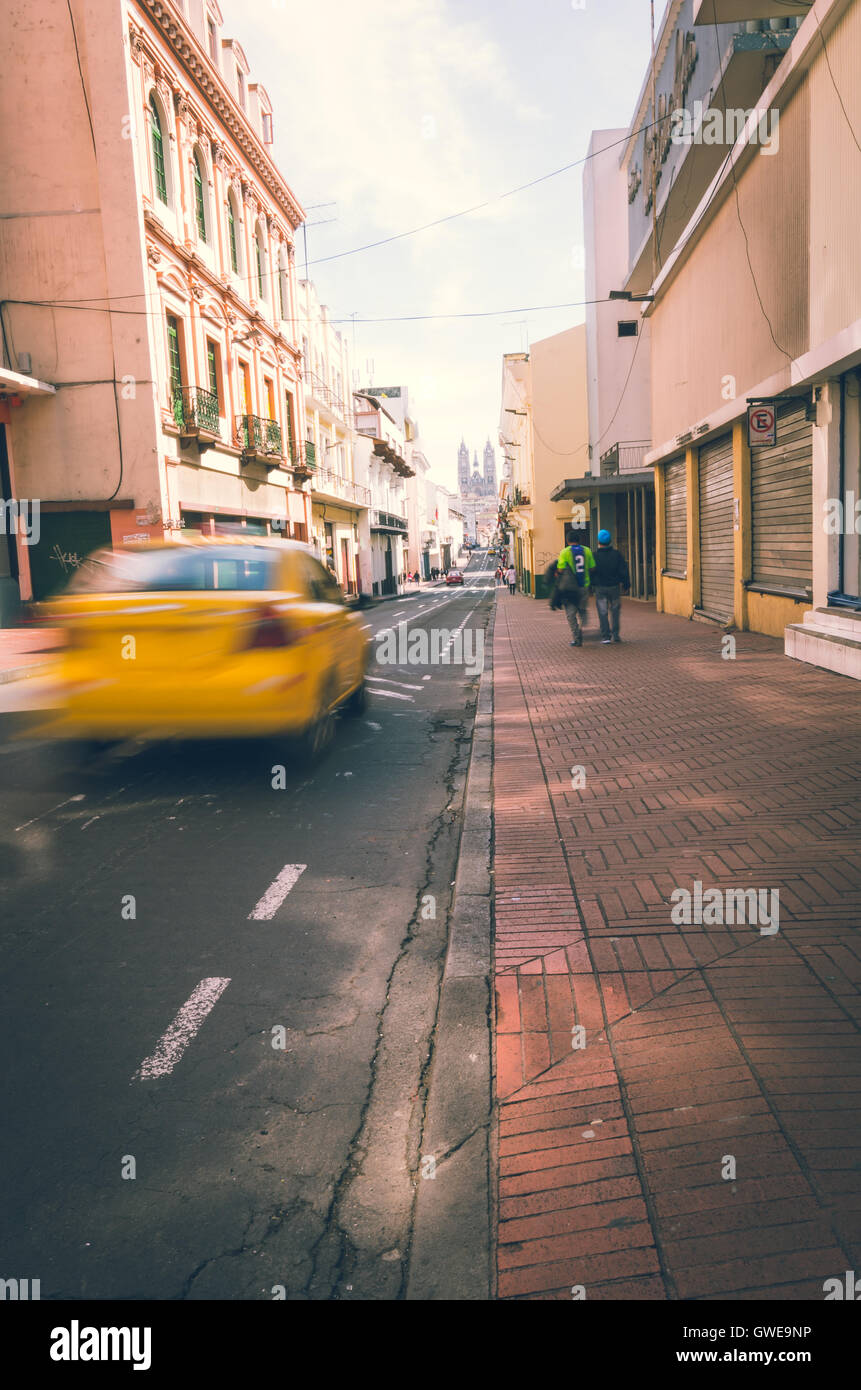 Red sidewalk and pavement street that ends with a church, taxi cab ...